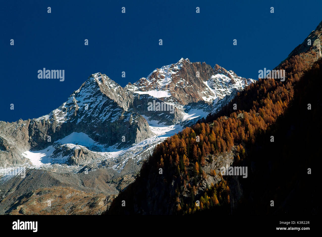 Mount Disgrazia and Mount Pioda surrounded by autumn colors of the ...