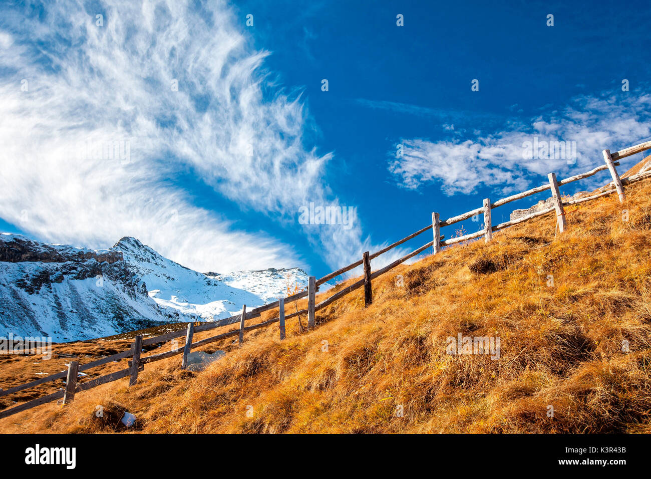 The cold autumn wind blowing some clouds, making strange drawings in ...
