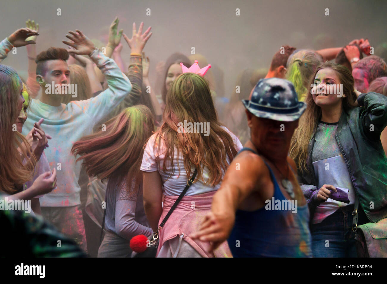 Young, happy people dancing during the holi festival of colours ...
