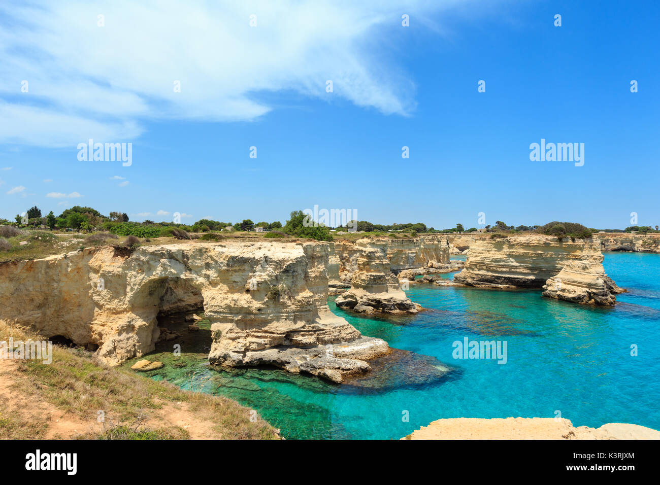 Picturesque seascape with cliffs, rocky arch and stacks (faraglioni ...