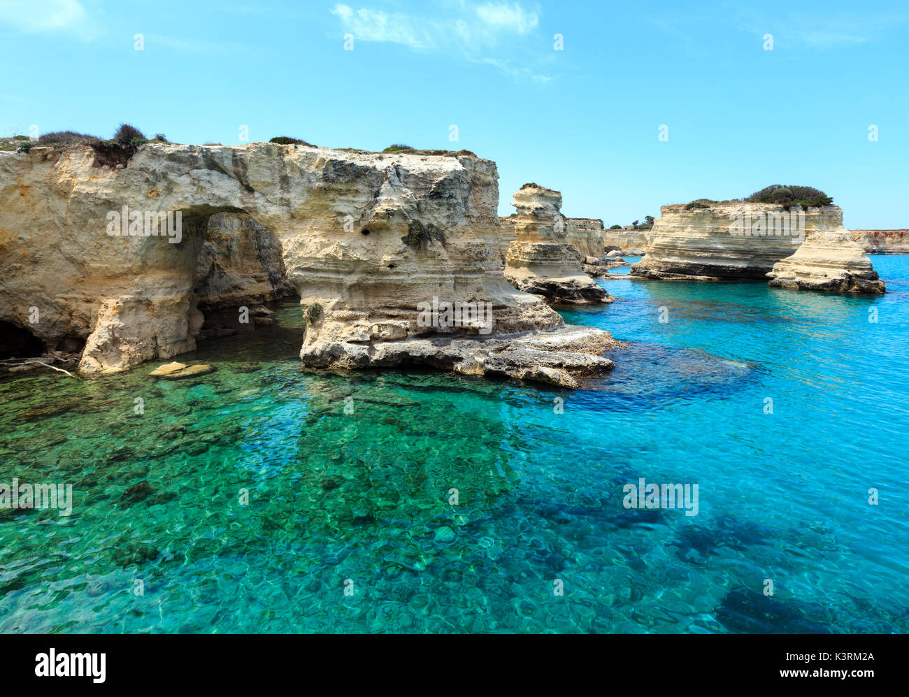 Picturesque seascape with cliffs, rocky arch and stacks (faraglioni ...