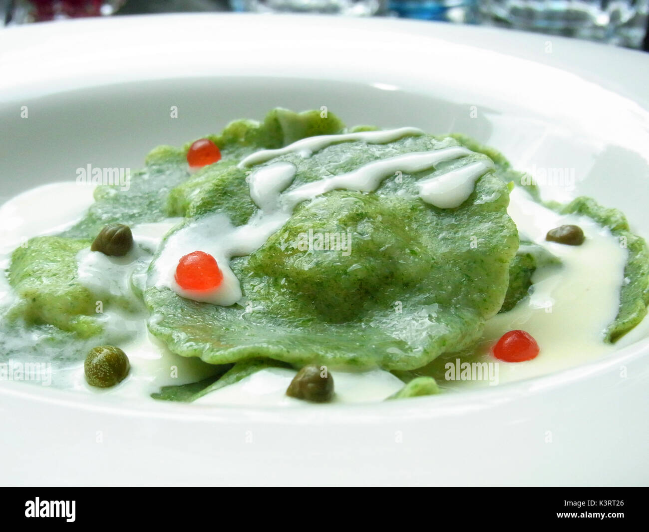 green ravioli made from spinach cooked with salmon roe, olive and white ...