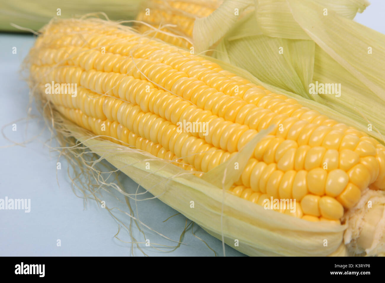 Fresh corn on cobs on texture background, closeup, top view Stock Photo ...
