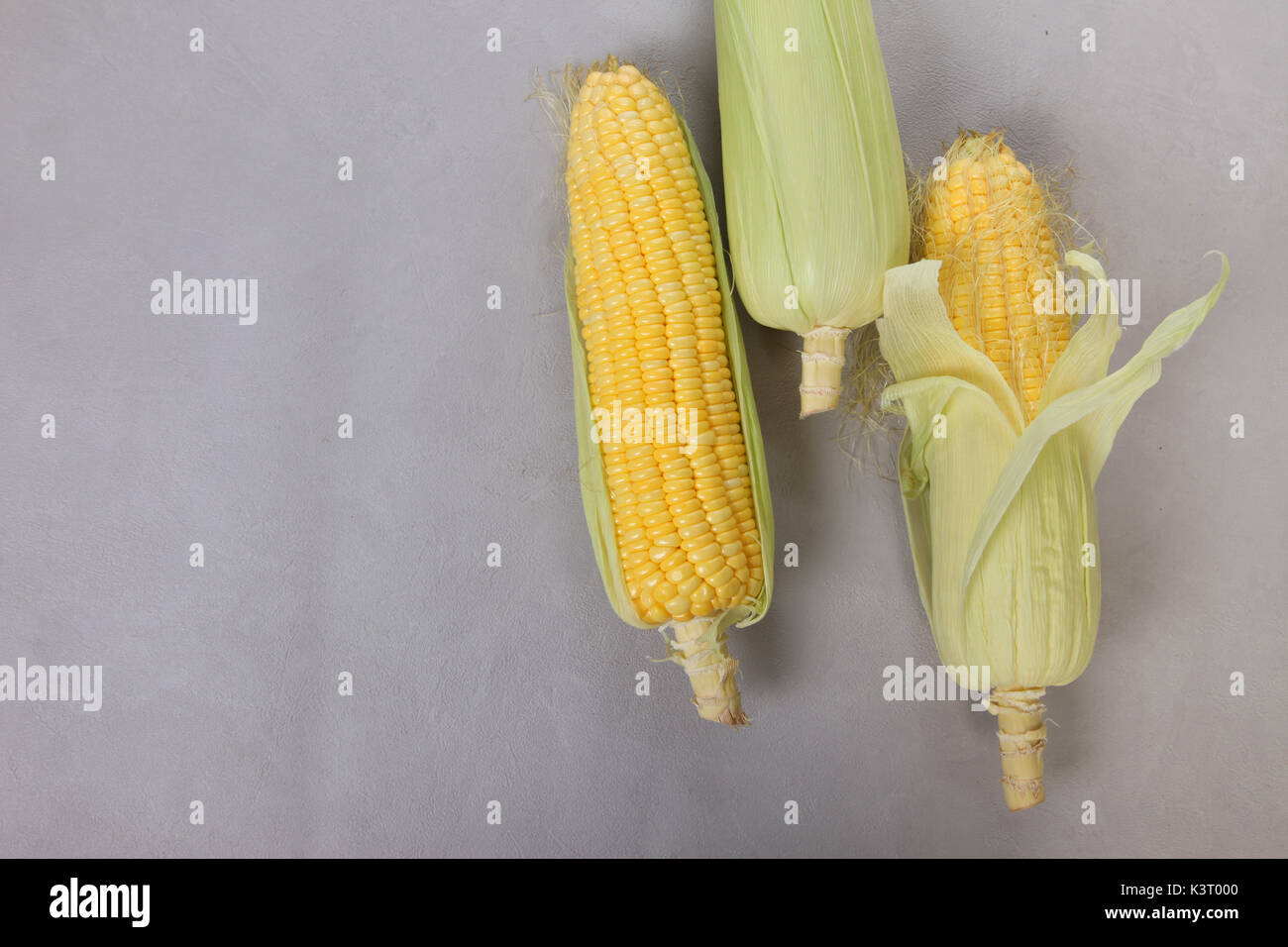 Fresh corn on cobs on texture background, closeup, top view Stock Photo ...