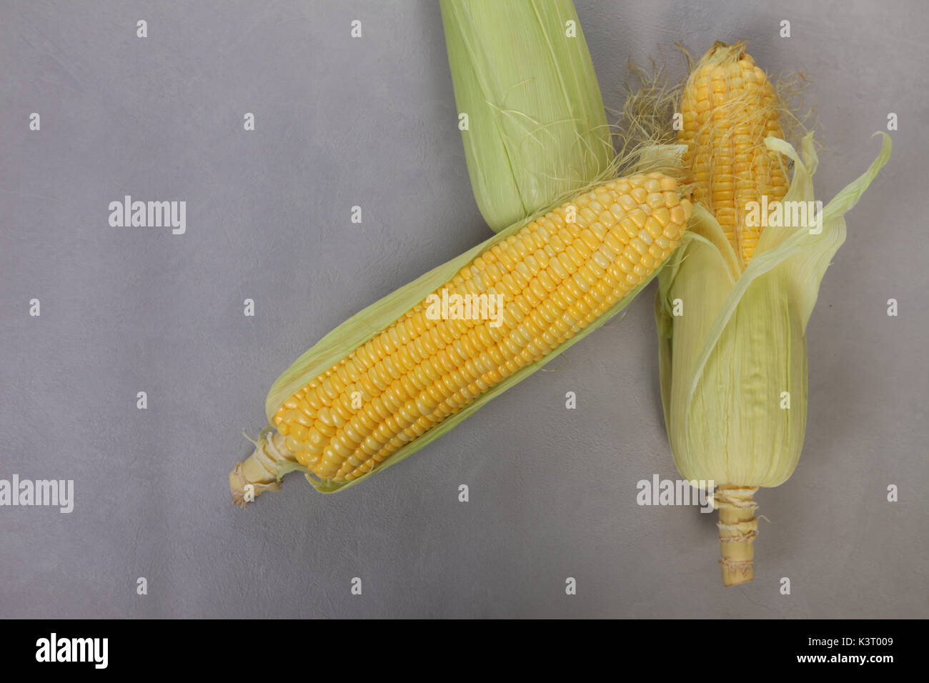 Fresh corn on cobs on texture background, closeup, top view Stock Photo ...