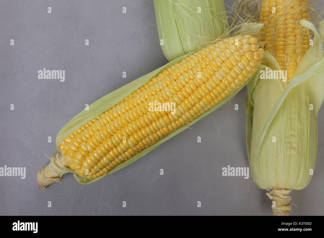 Fresh corn on cobs on texture background, closeup, top view Stock Photo ...