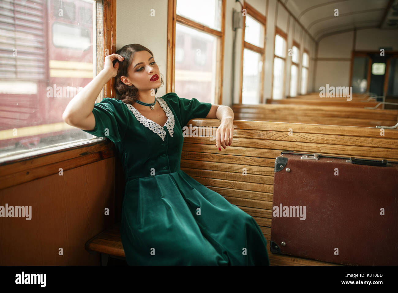 Female traveler in retro train, old wagon interior. Railroad voyage ...