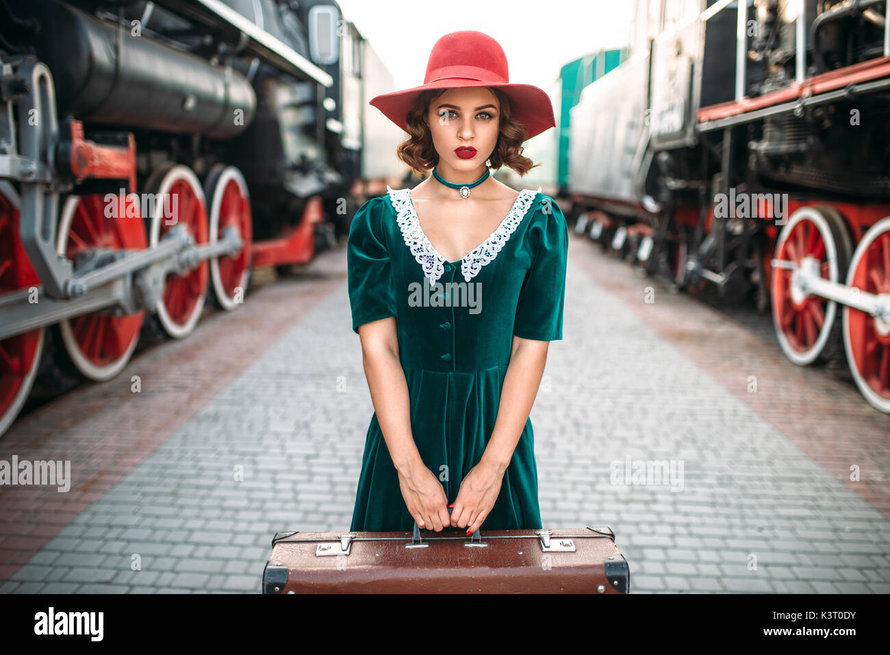 Young old-fashioned woman travels on retro train. Old locomotive ...