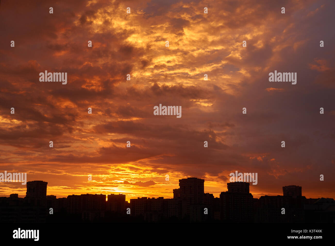 Beautiful sunset scene in the city with dark silhouettes of buildings ...