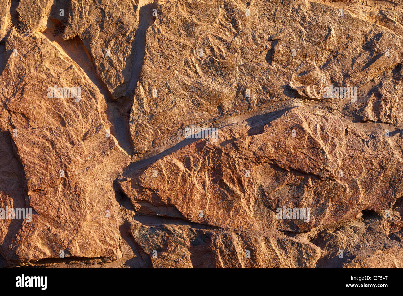 Red stone textured finishing on the foundation of the house Stock Photo ...