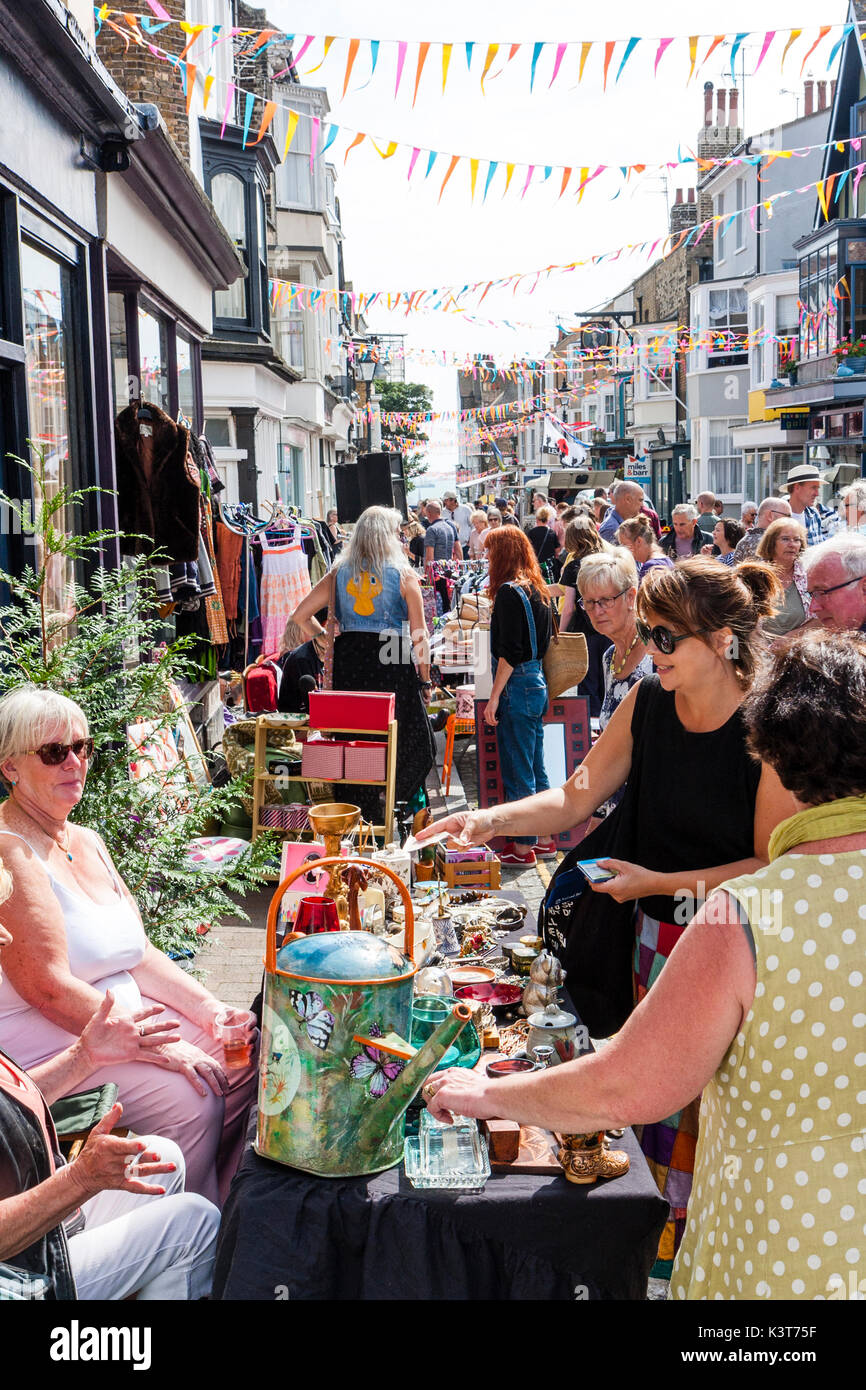 English town street fair. Narrow street with stalls with traders and ...
