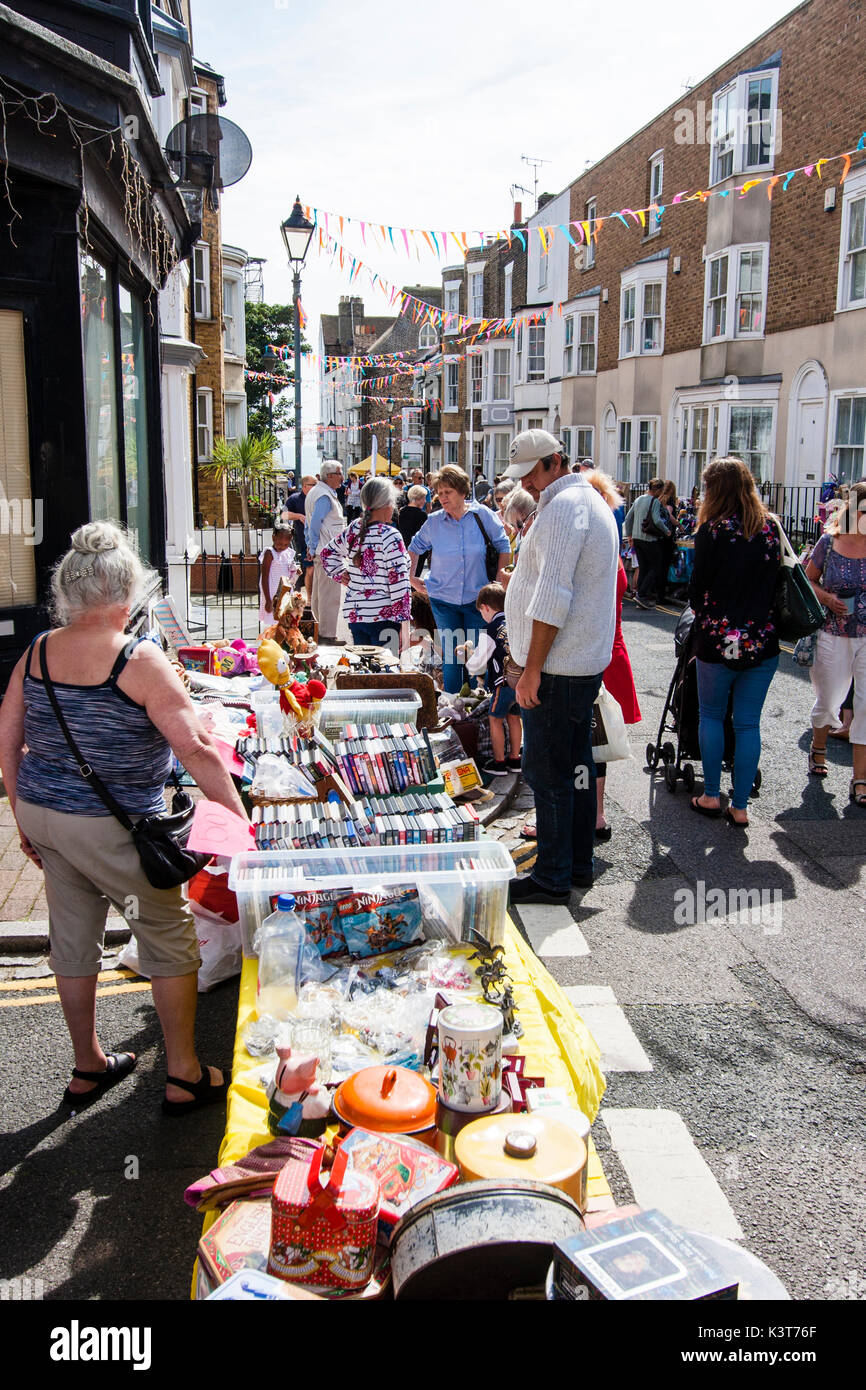 English town street fair. Narrow street with stalls with traders and ...