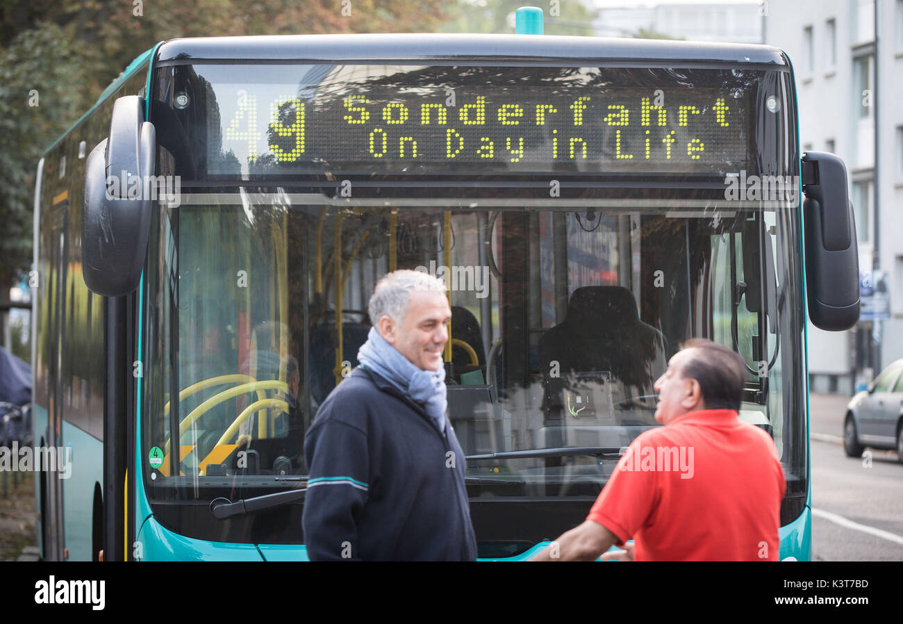 Bus drivers are waiting at their busses to transport people out of the ...