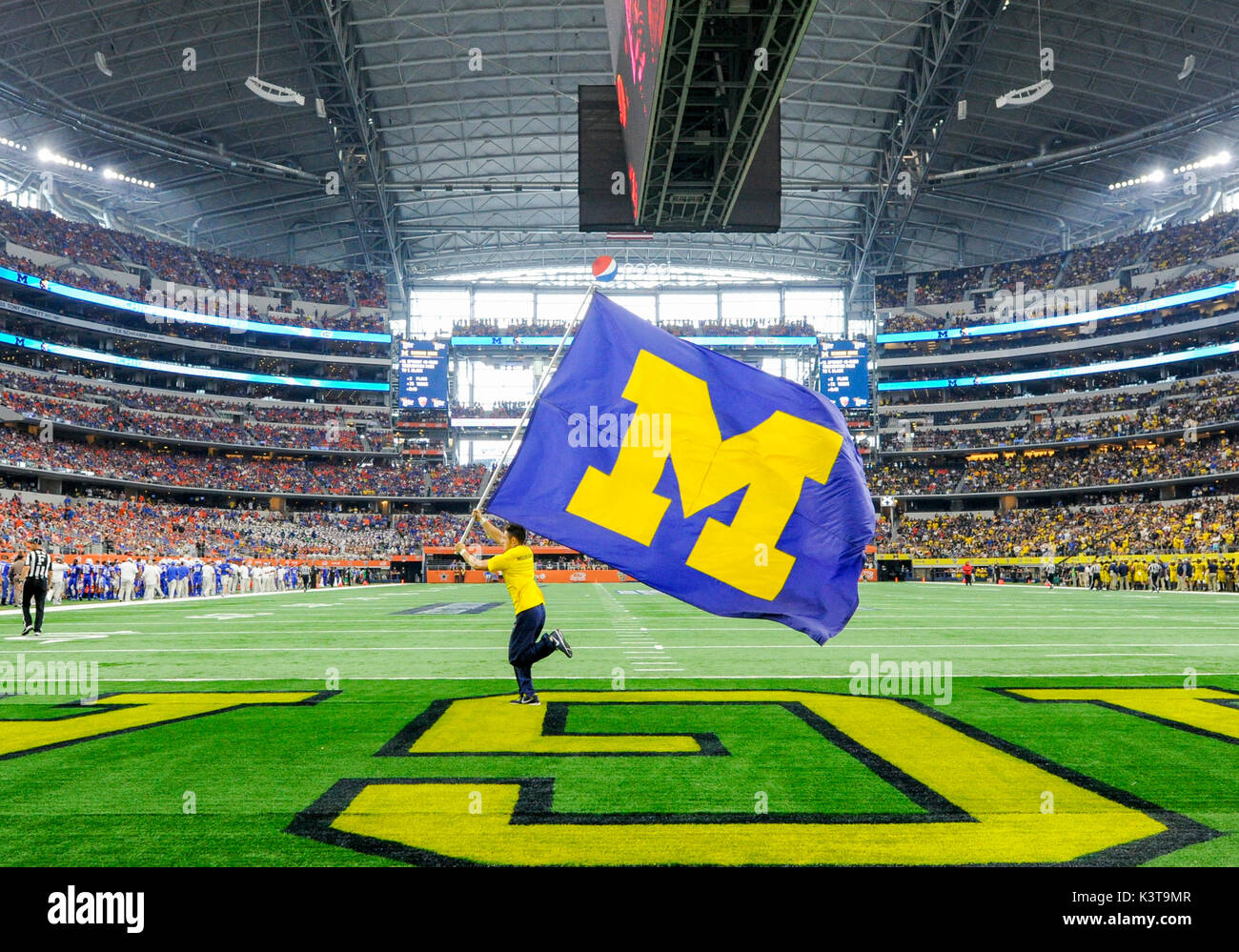 September 02, 2017: A Michigan Wolverines flag runner crosses the end ...