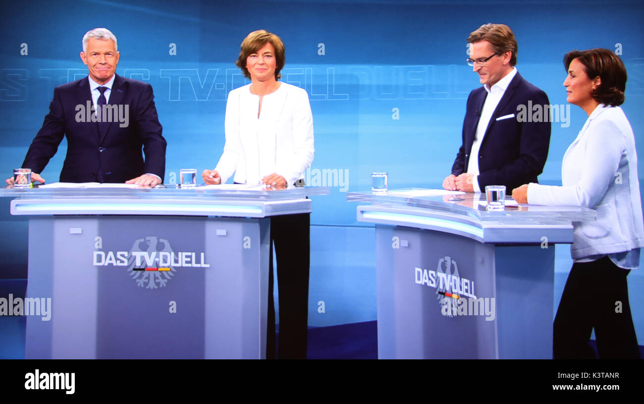 A screen that shows the hosts Sandra Maischberger (R-L), Claus Strunz ...