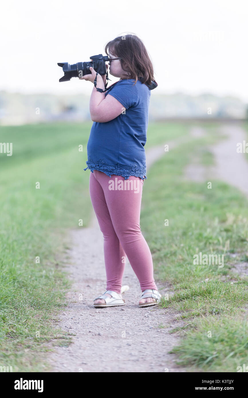 Young girl using a Canon camera Stock Photo - Alamy