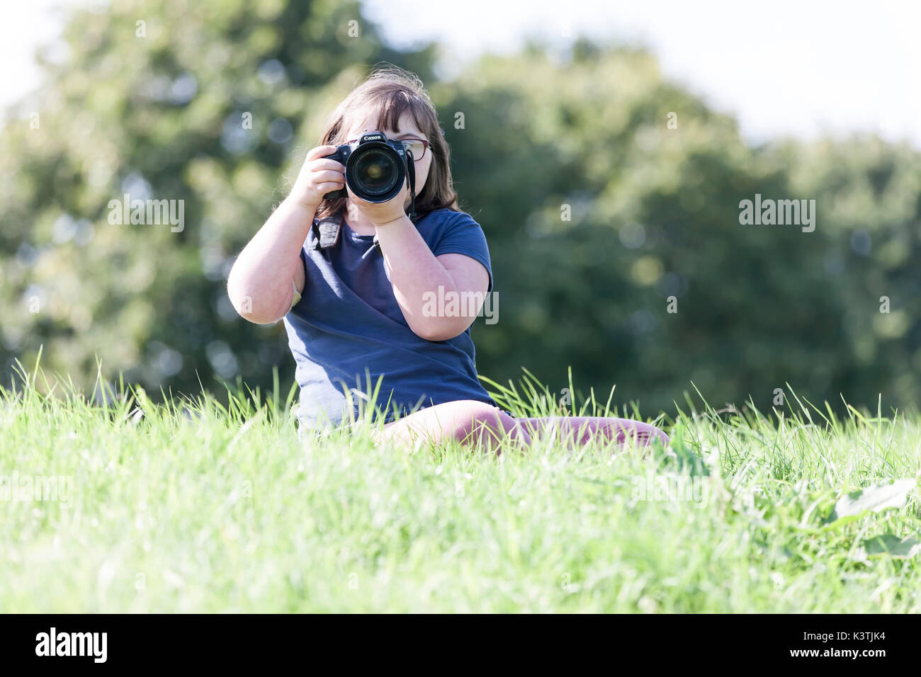 Young girl using a Canon camera Stock Photo - Alamy