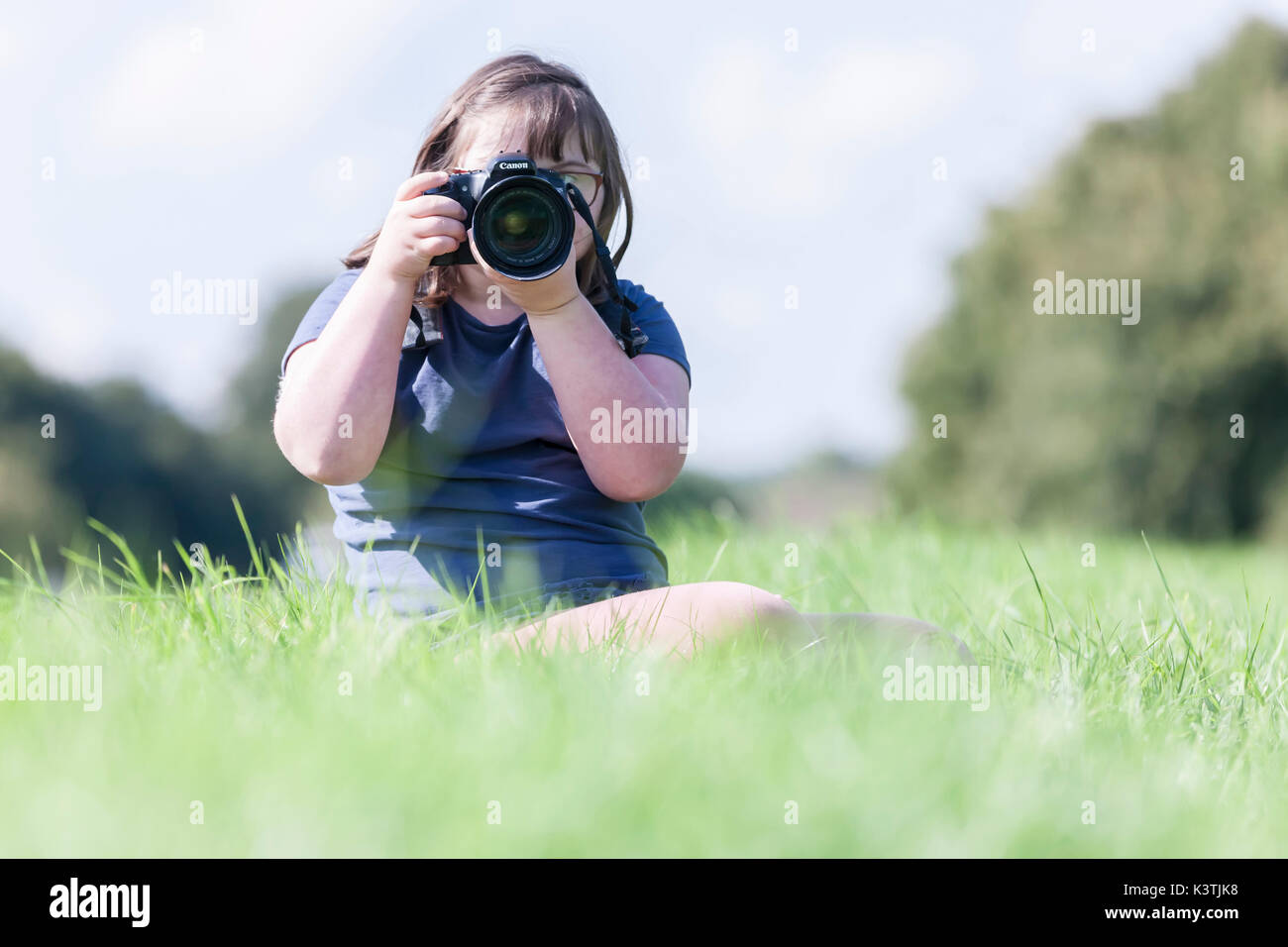 Young girl using a Canon camera Stock Photo - Alamy