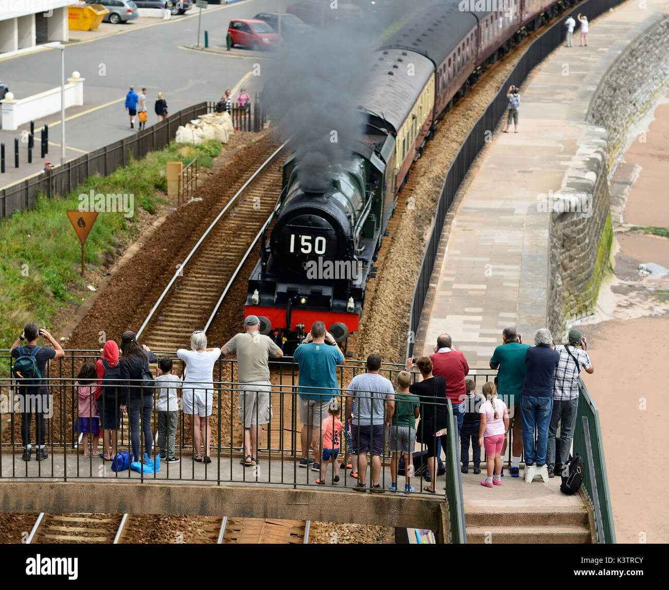 People watching the Royal Duchy steam train passing through Dawlish ...
