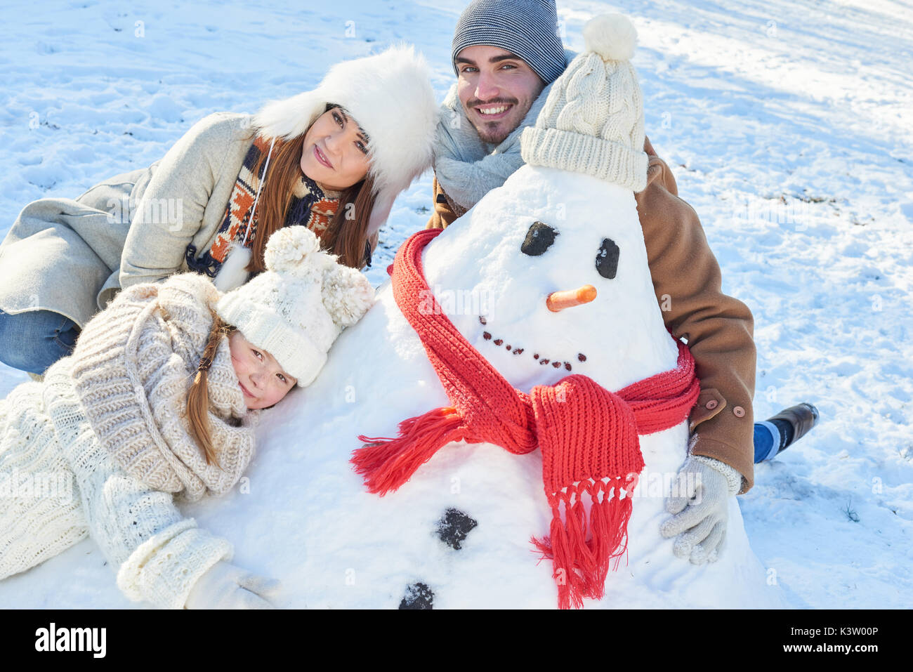 Family with snowman hi-res stock photography and images - Alamy
