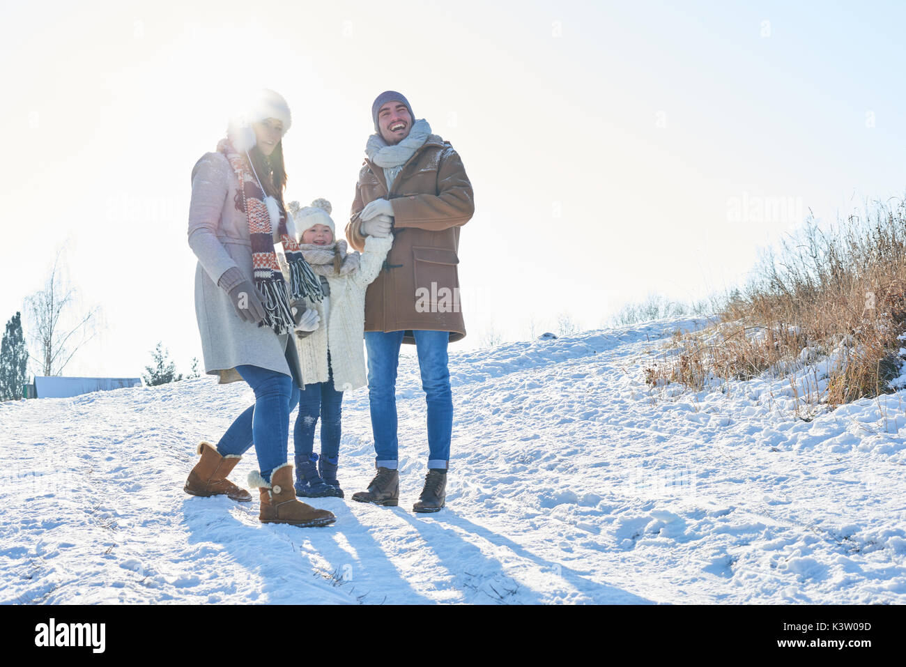Happy family in winter holiday trip with child playing with snow Stock ...