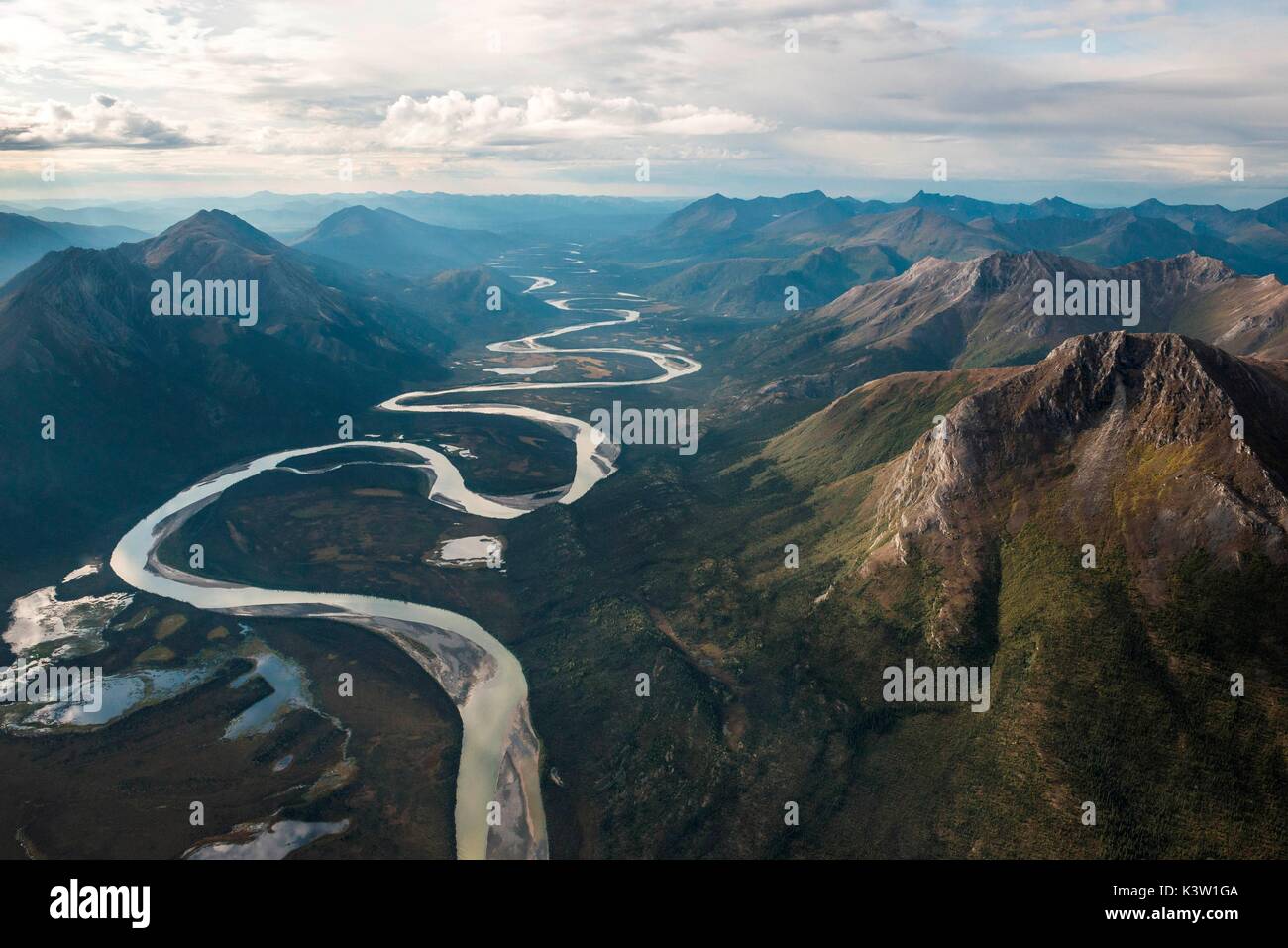 A river winds through the treeless slopes of the Brooks Range mountains ...