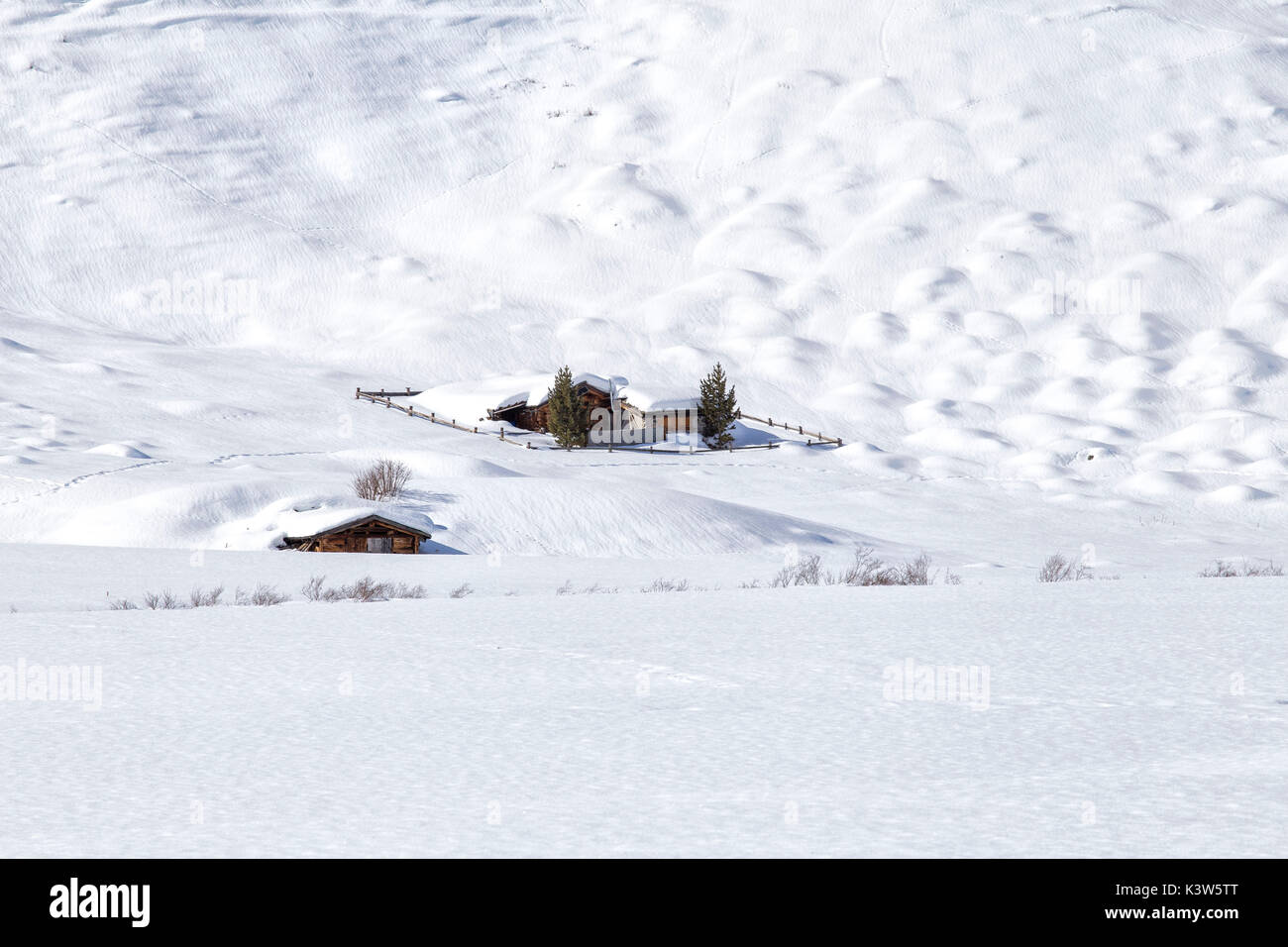 Small isolated huts in the winter landscape of Sertigtal. Sertig Dorfli ...