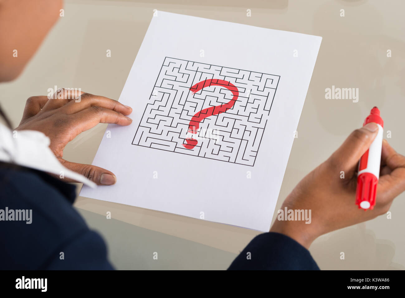Close-up Of A Person's Hand With Question Mark On Maze Stock Photo - Alamy