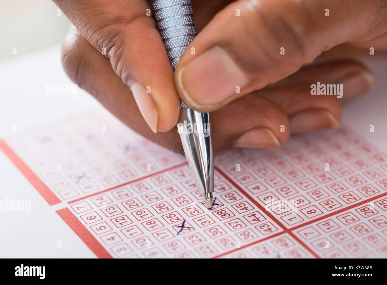 Close-up Of Person's Hand Marking Number On Lottery Ticket With Pen ...