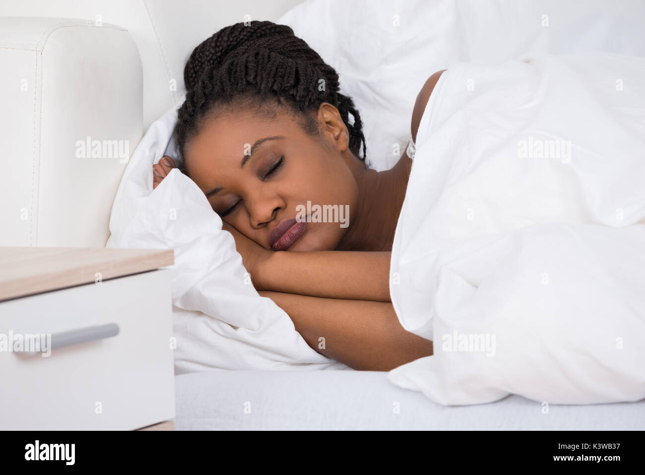 Portrait Of A Young African Woman Sleeping On Bed Stock Photo - Alamy