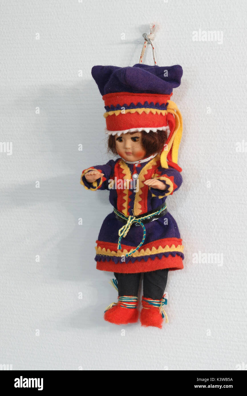 Finnish arctic doll girl hanging on white wall Stock Photo - Alamy