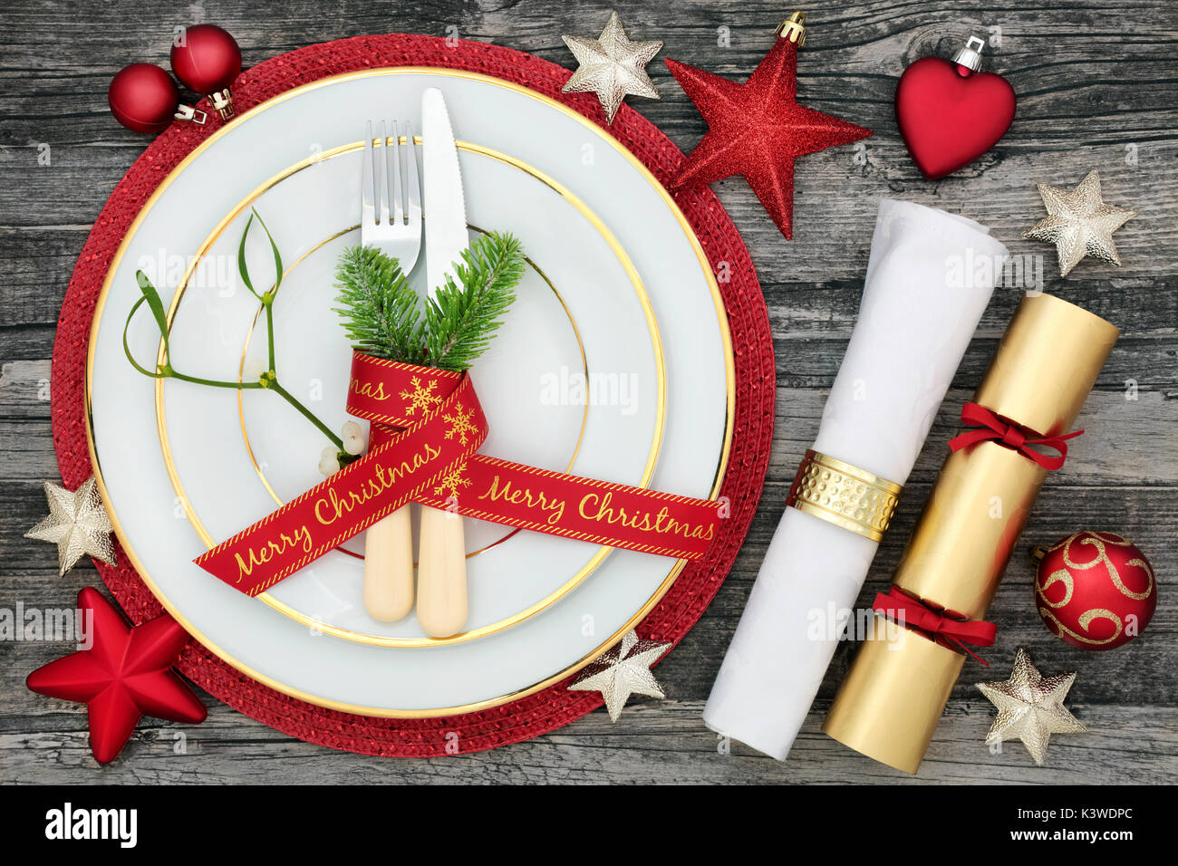 Christmas table place setting with dinner plates, cutlery with fir and ...
