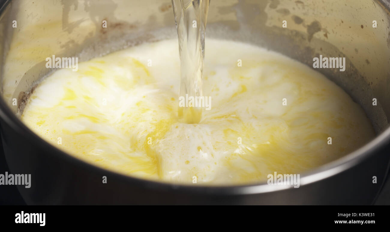 add water to mix of melted butter with water Stock Photo - Alamy
