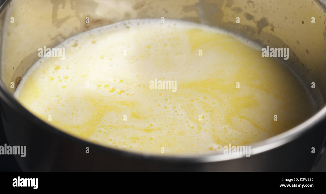 add water to mix of melted butter with water Stock Photo - Alamy