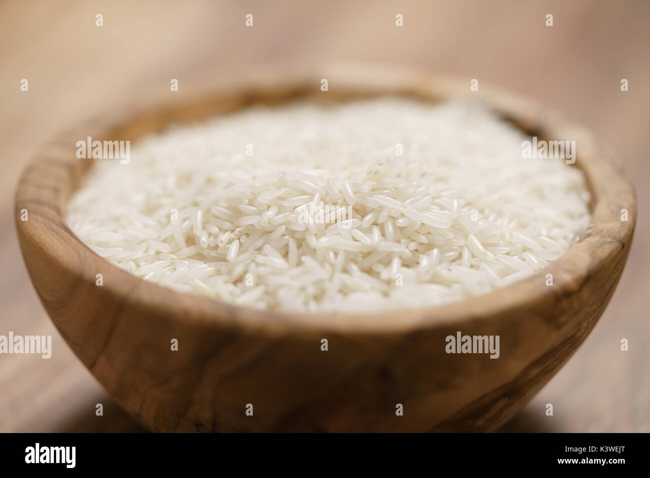 dry basmati rice in wood bowl on table Stock Photo - Alamy