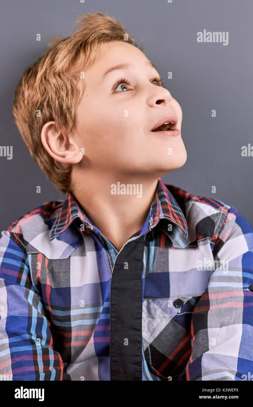 Portrait of excited little boy. Close up studio portrait of a cute ...