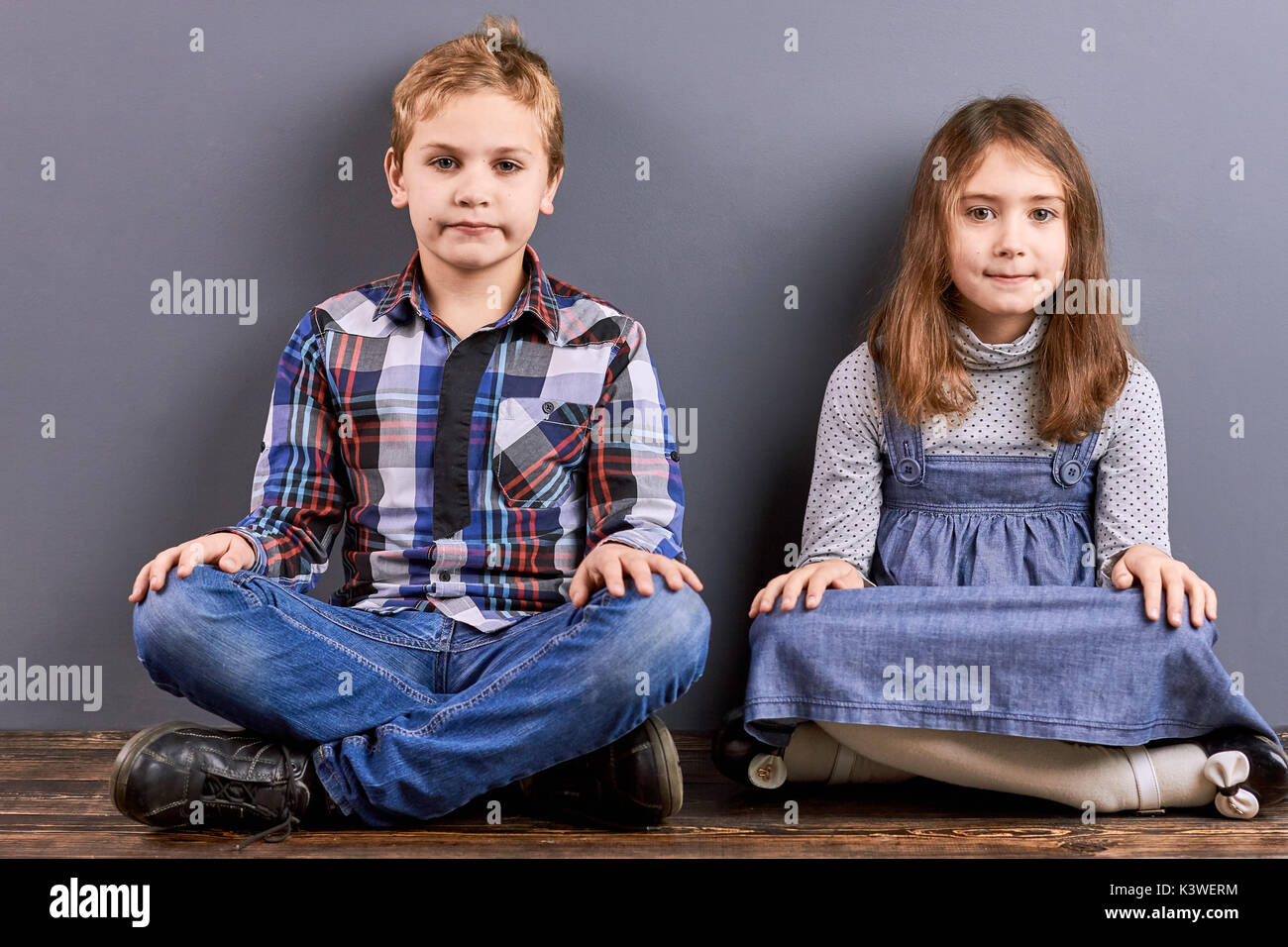 Portrait of kids with crossed legs. Portrait of little sister and ...