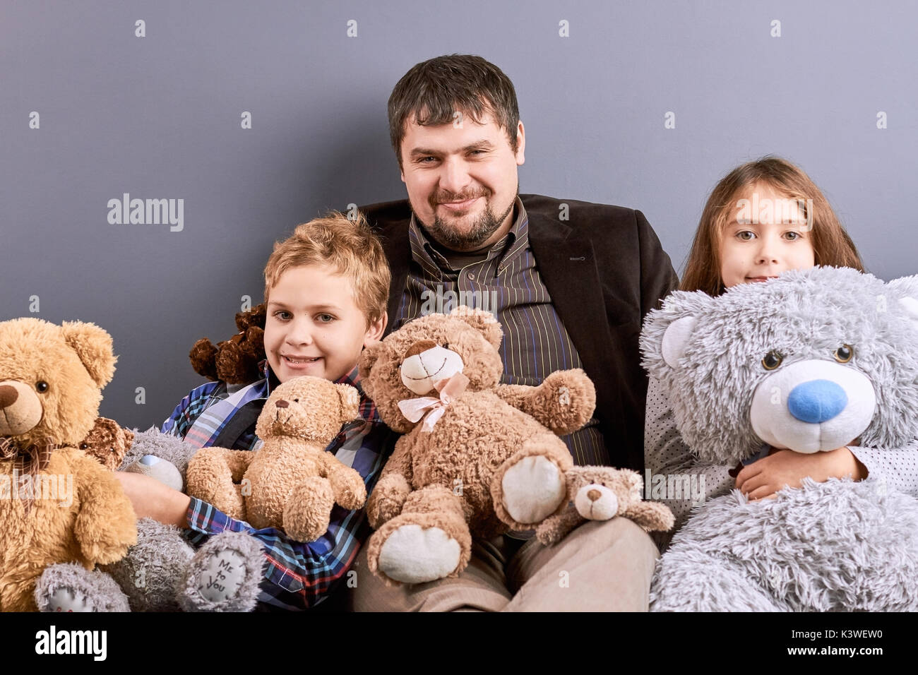 Happy father, kids, toys, portrait. Beautiful studio portrait of father ...