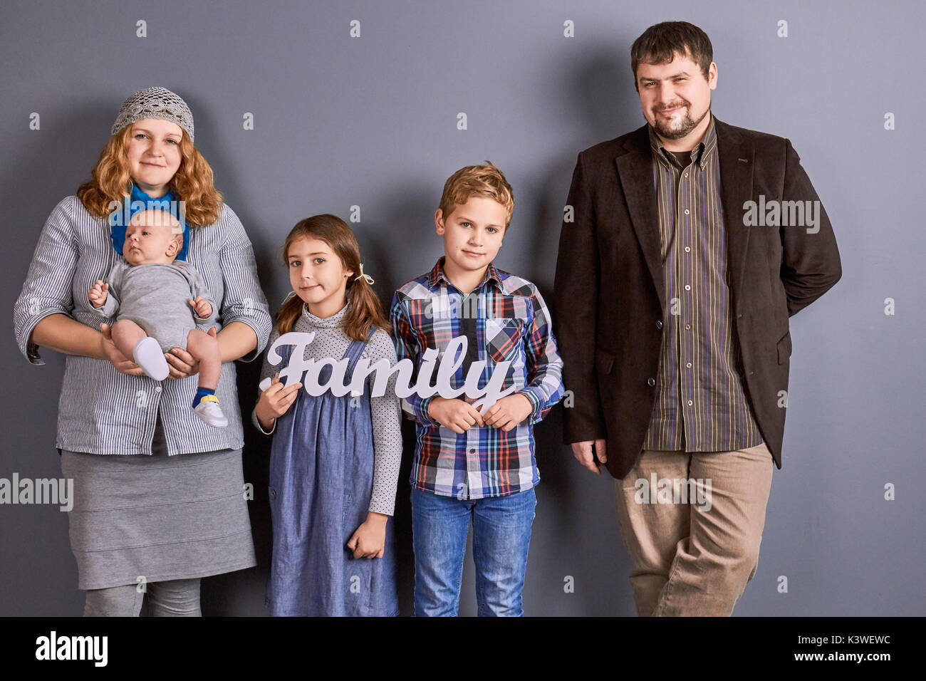 Portrait of young family with kids. Studio shot of young european ...