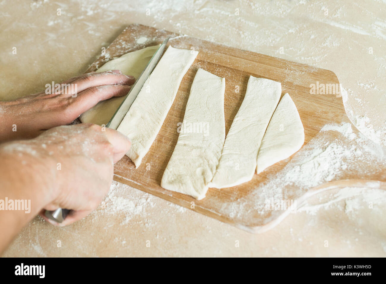 Cook cuts dough hi-res stock photography and images - Alamy