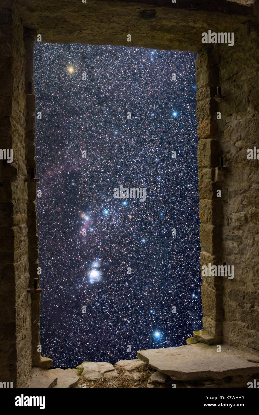 The Orion constellation visible through an old ancient stone window ...