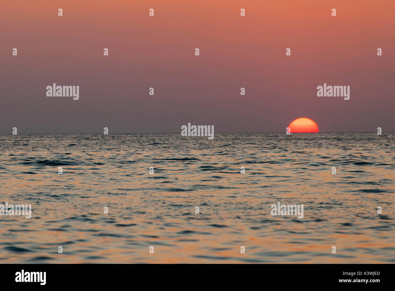 Multi colored sunset over tropical sea Stock Photo - Alamy