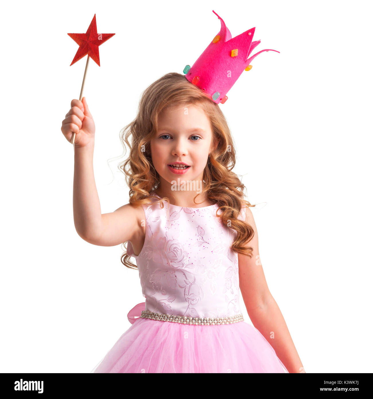Little fairy girl in pink dress and crown with magic wand putting spell ...