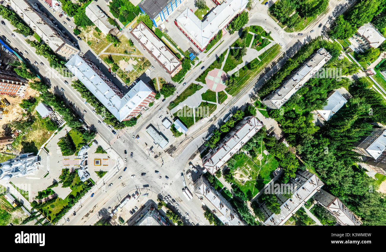 Aerial city view with crossroads and roads, houses, buildings, parks ...