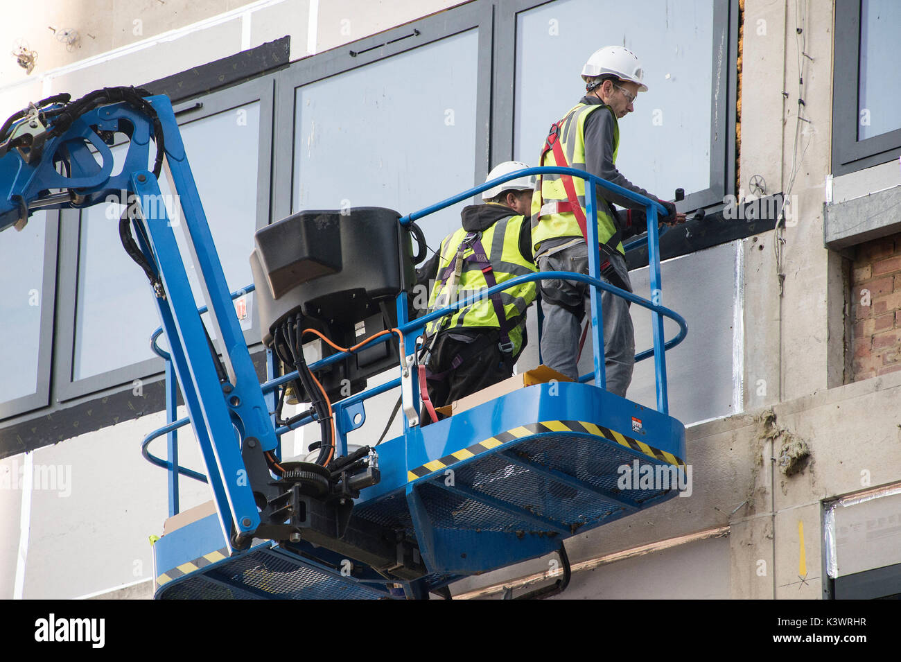 Construction workers on a building site Stock Photo - Alamy