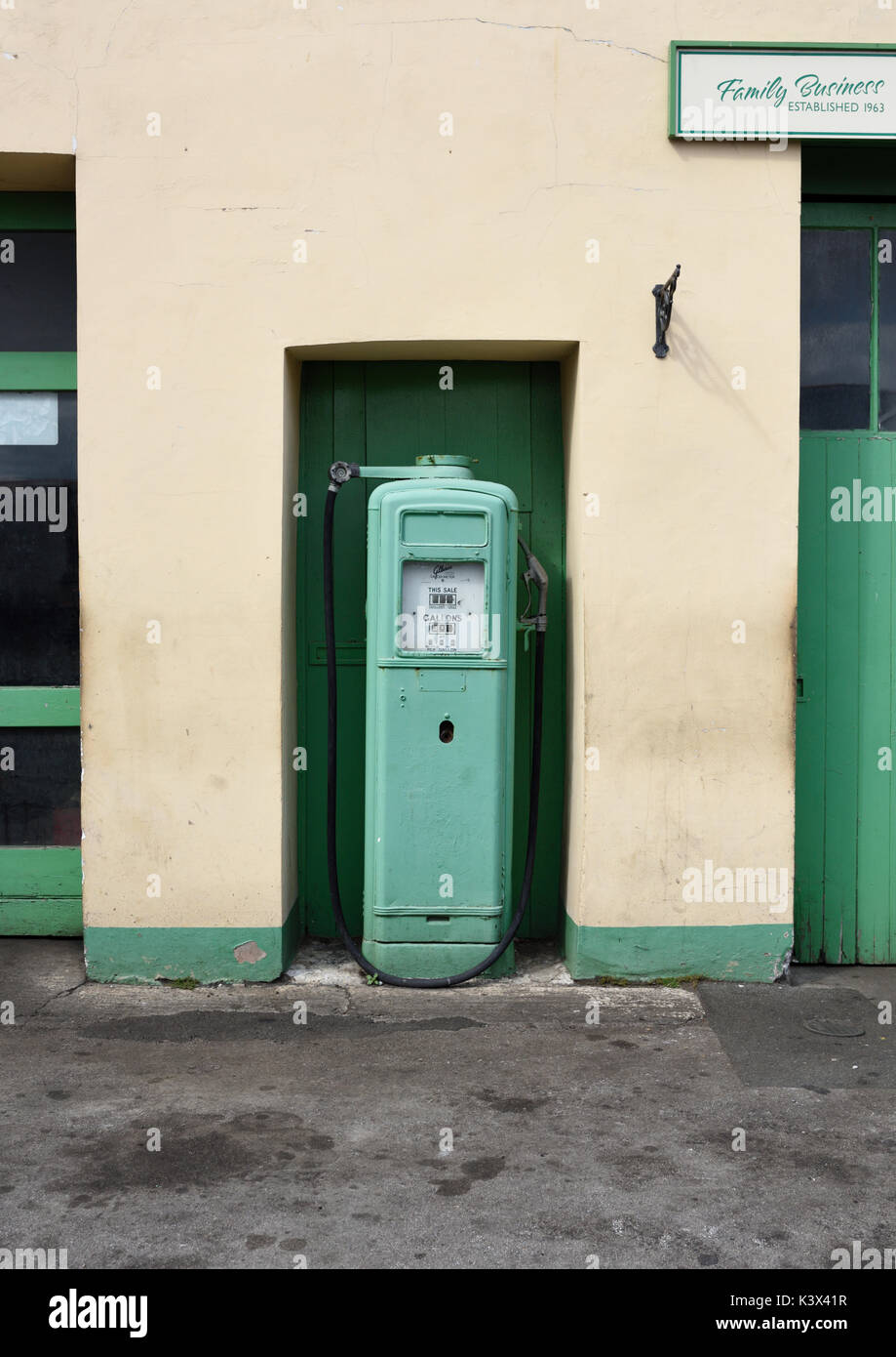 Green painted gilbarco calco-meter gas pump in front of cream and green ...