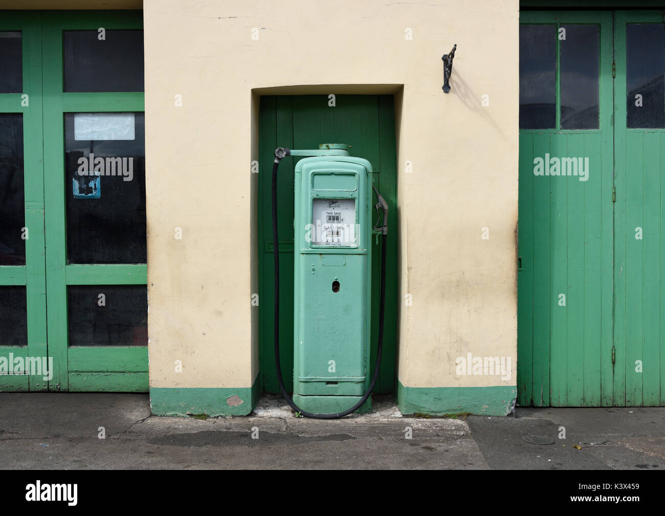 Green painted gilbarco calco-meter gas pump in front of cream and green ...