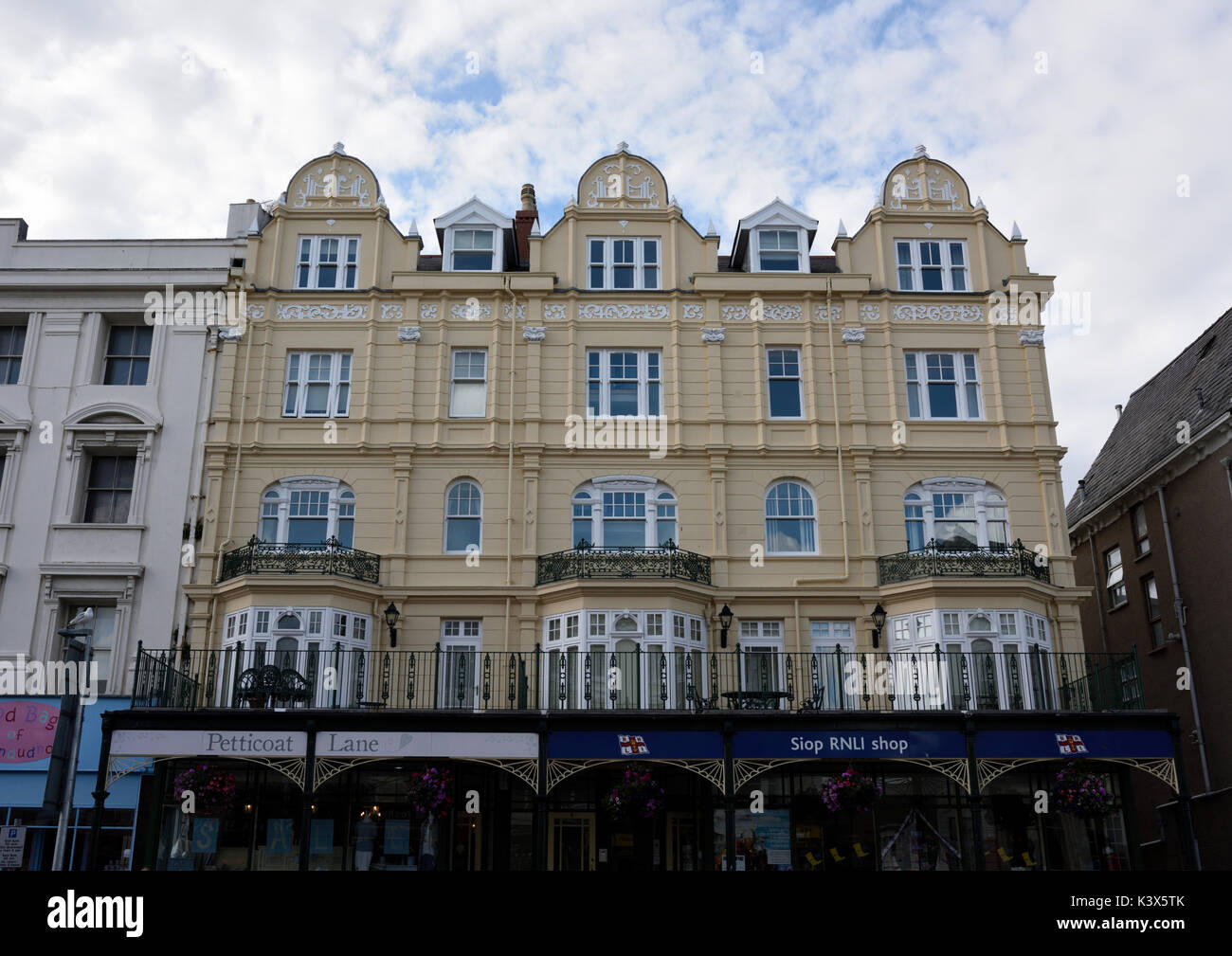 Building with cream painted frontage and cast iron verandah Stock Photo ...