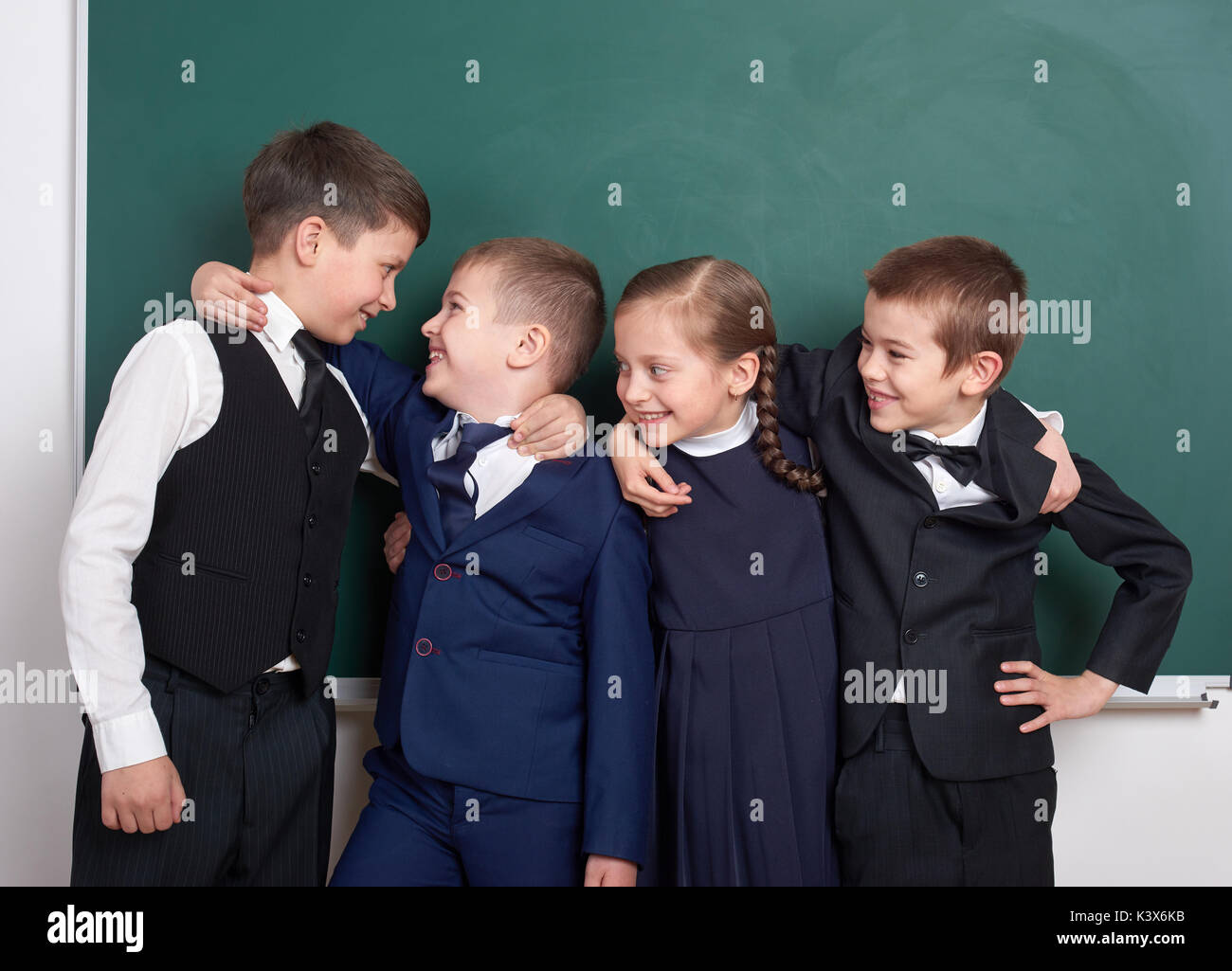 elementary school boy friends, fooling around near blank chalkboard ...