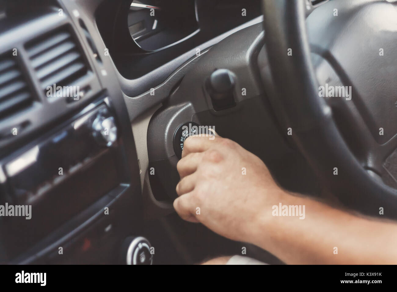 man's hand starts a car with the key in retro toning Stock Photo - Alamy
